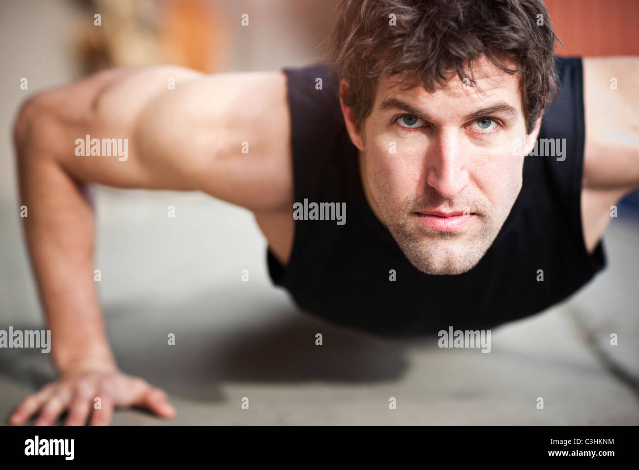 Portrait of man doing push-ups Stock Photo - Alamy