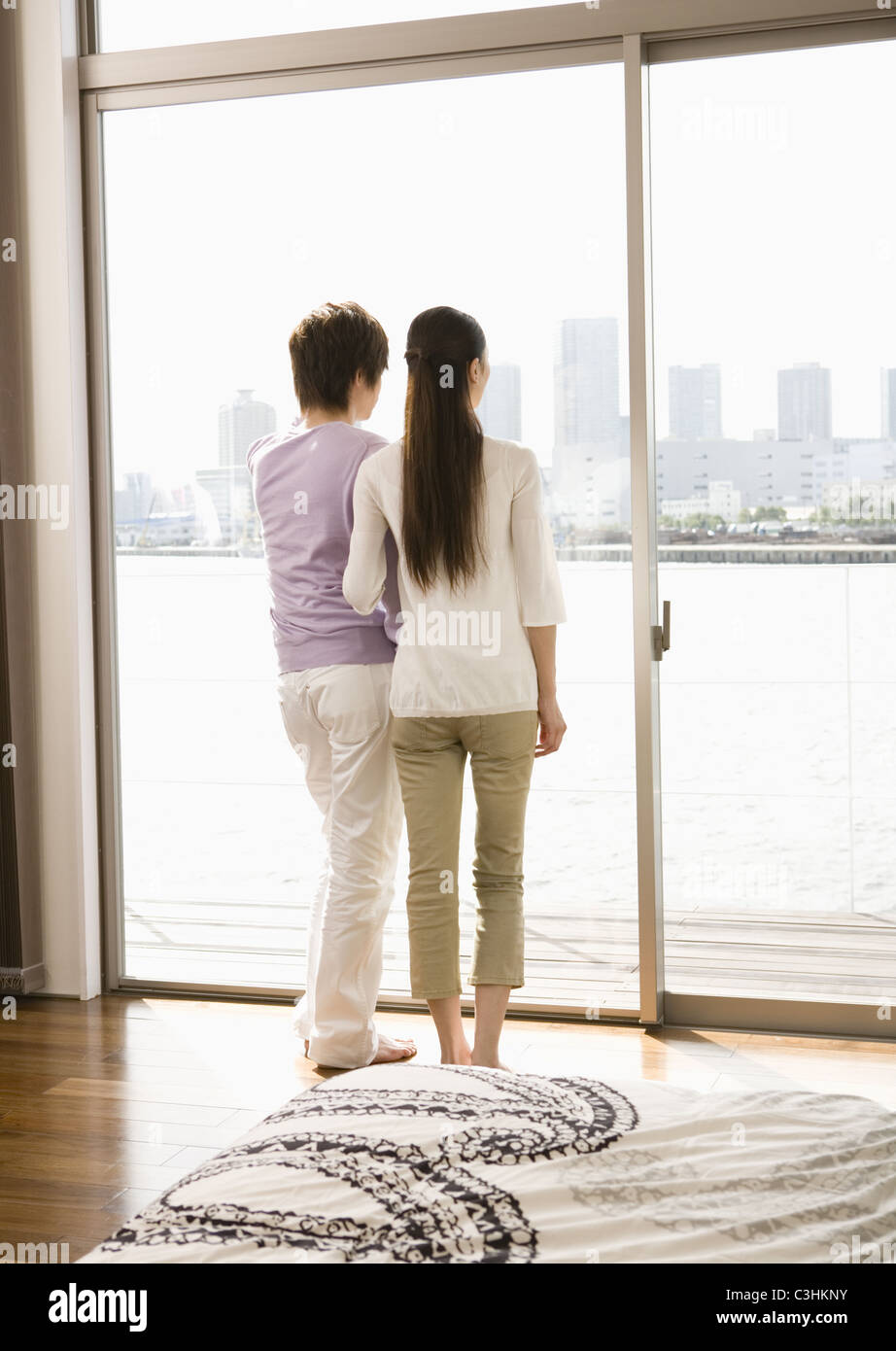 Couple looking outside Stock Photo - Alamy