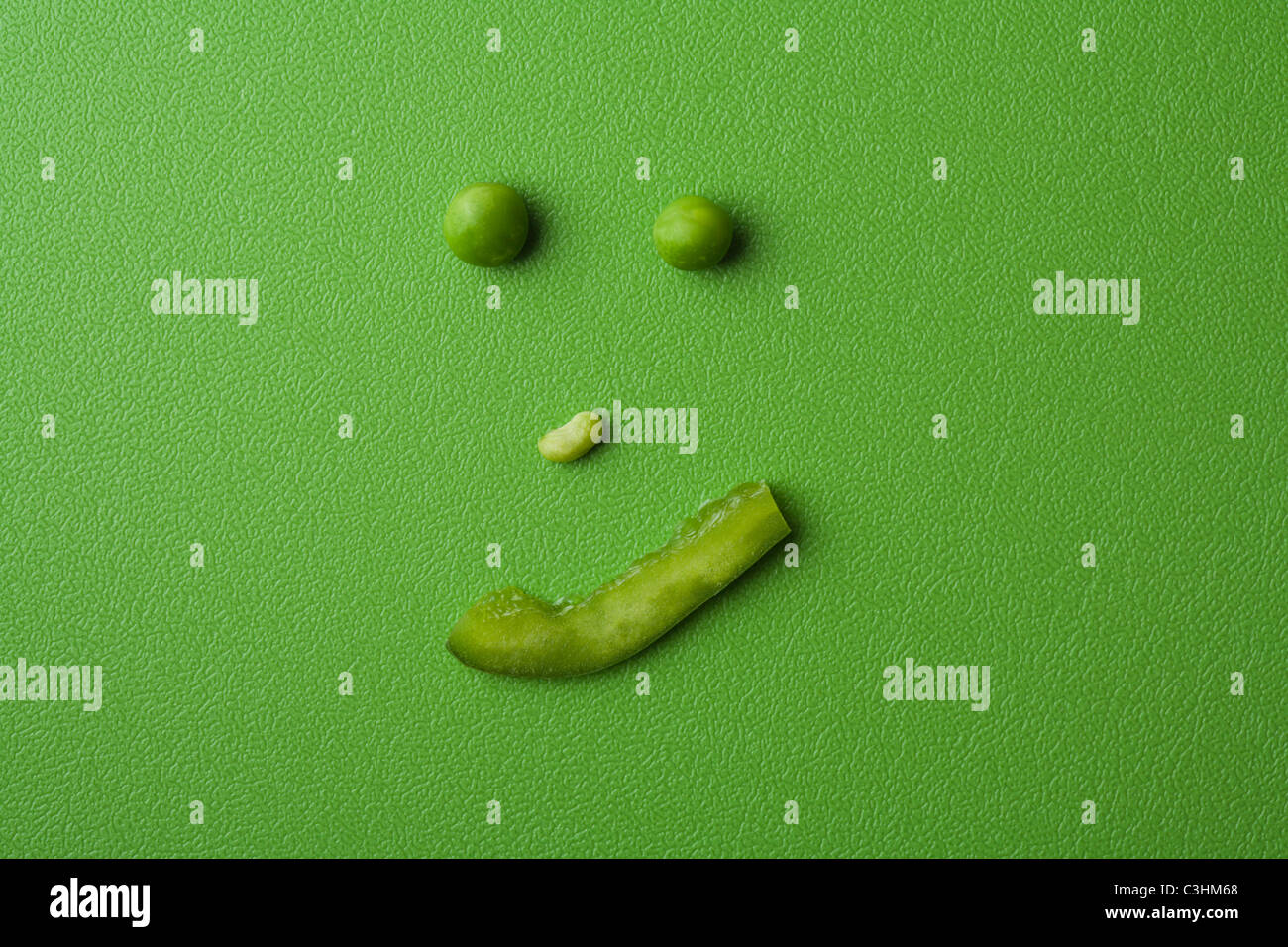Anthropomorphic face made up from green peas Stock Photo - Alamy