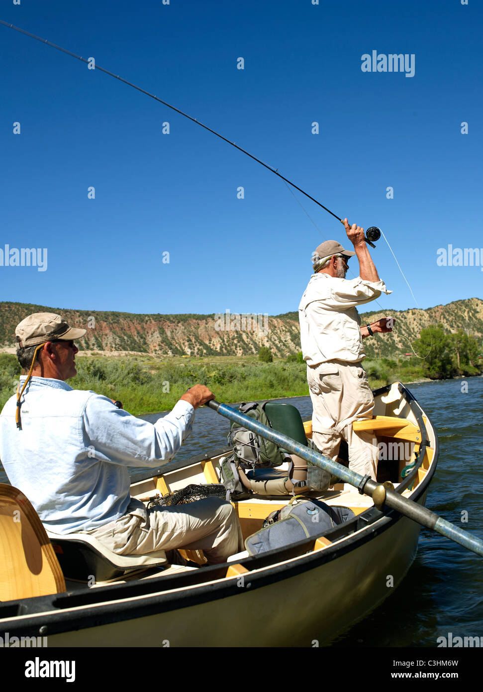 Vacations two men fishing rowing boat hi-res stock photography and ...