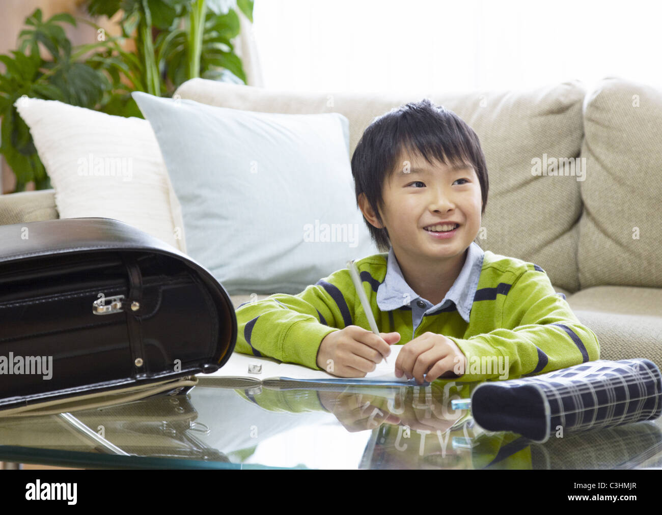 Boy doing homework Stock Photo - Alamy