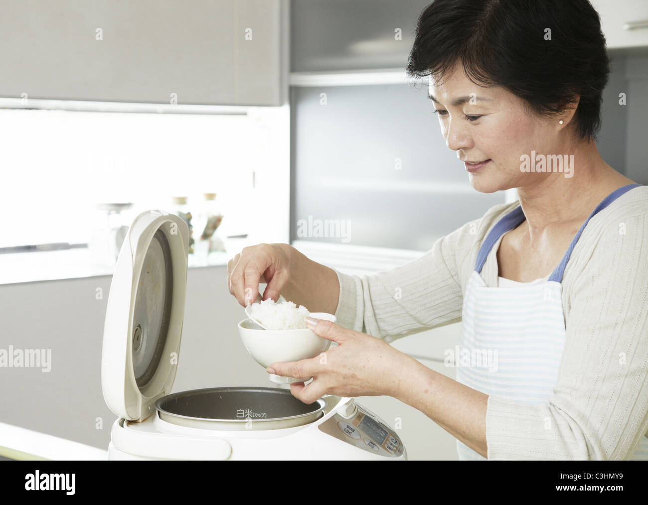 Woman serving rice Stock Photo - Alamy