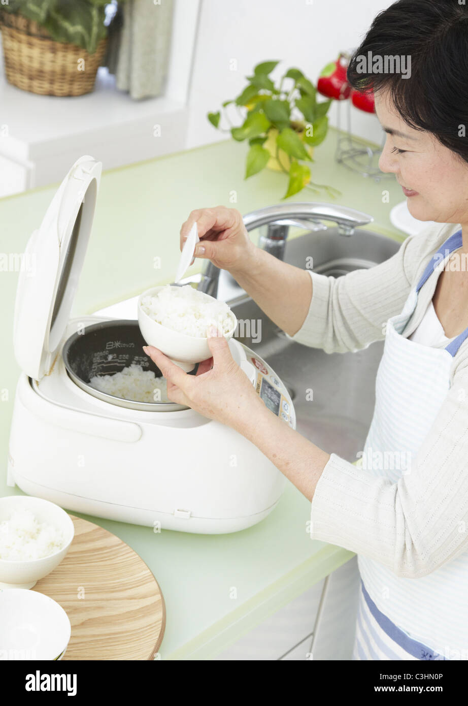 Woman serving rice Stock Photo - Alamy