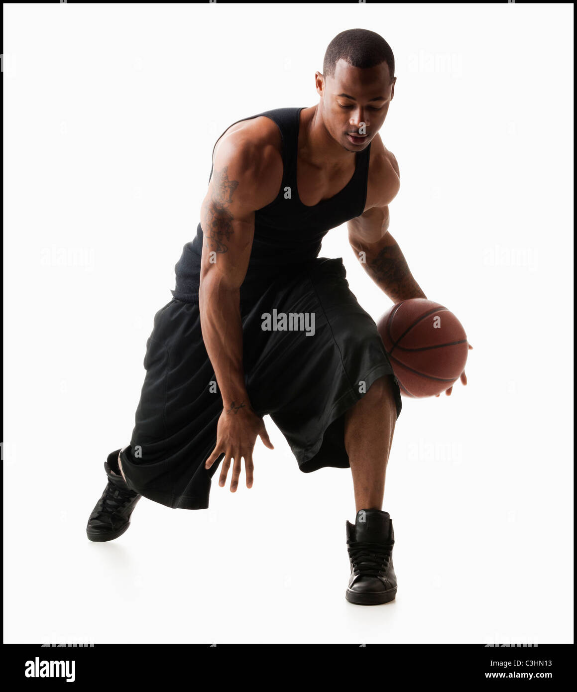 Studio shot of man playing basketball Stock Photo - Alamy