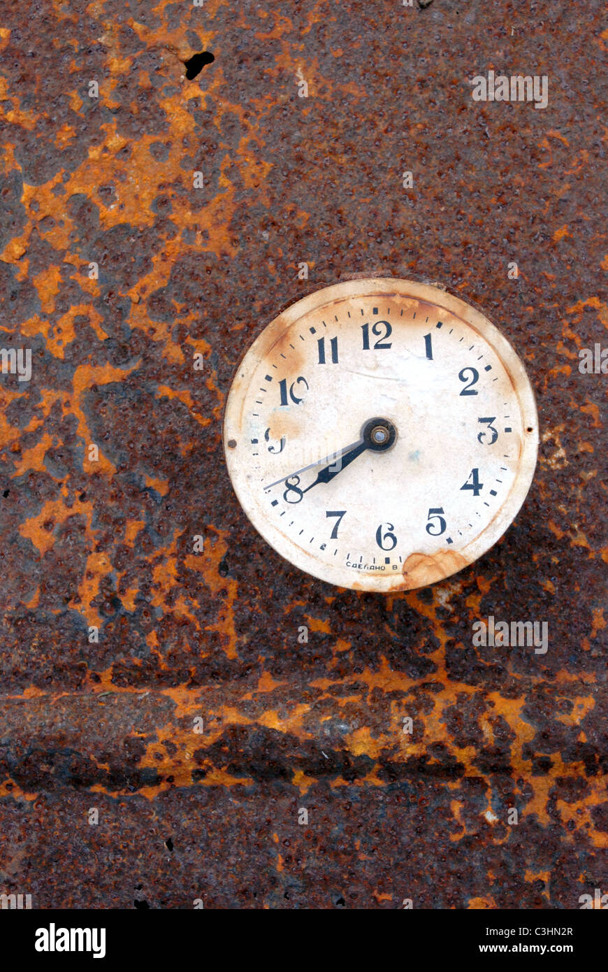 rusted time symbol -old clock-face on rusted tin background Stock Photo ...