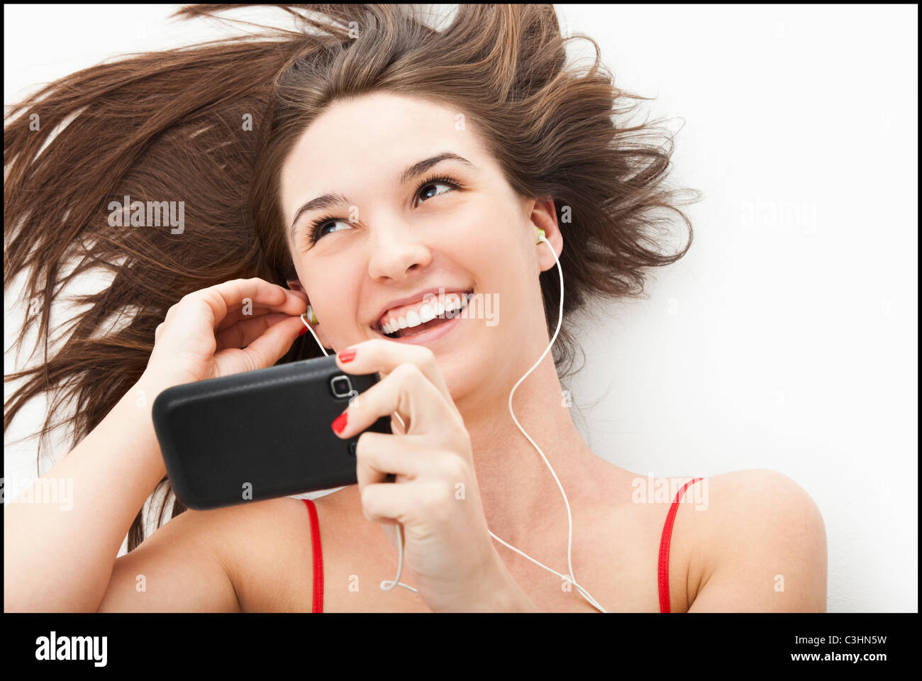 Young woman listening to mp3 player Stock Photo - Alamy
