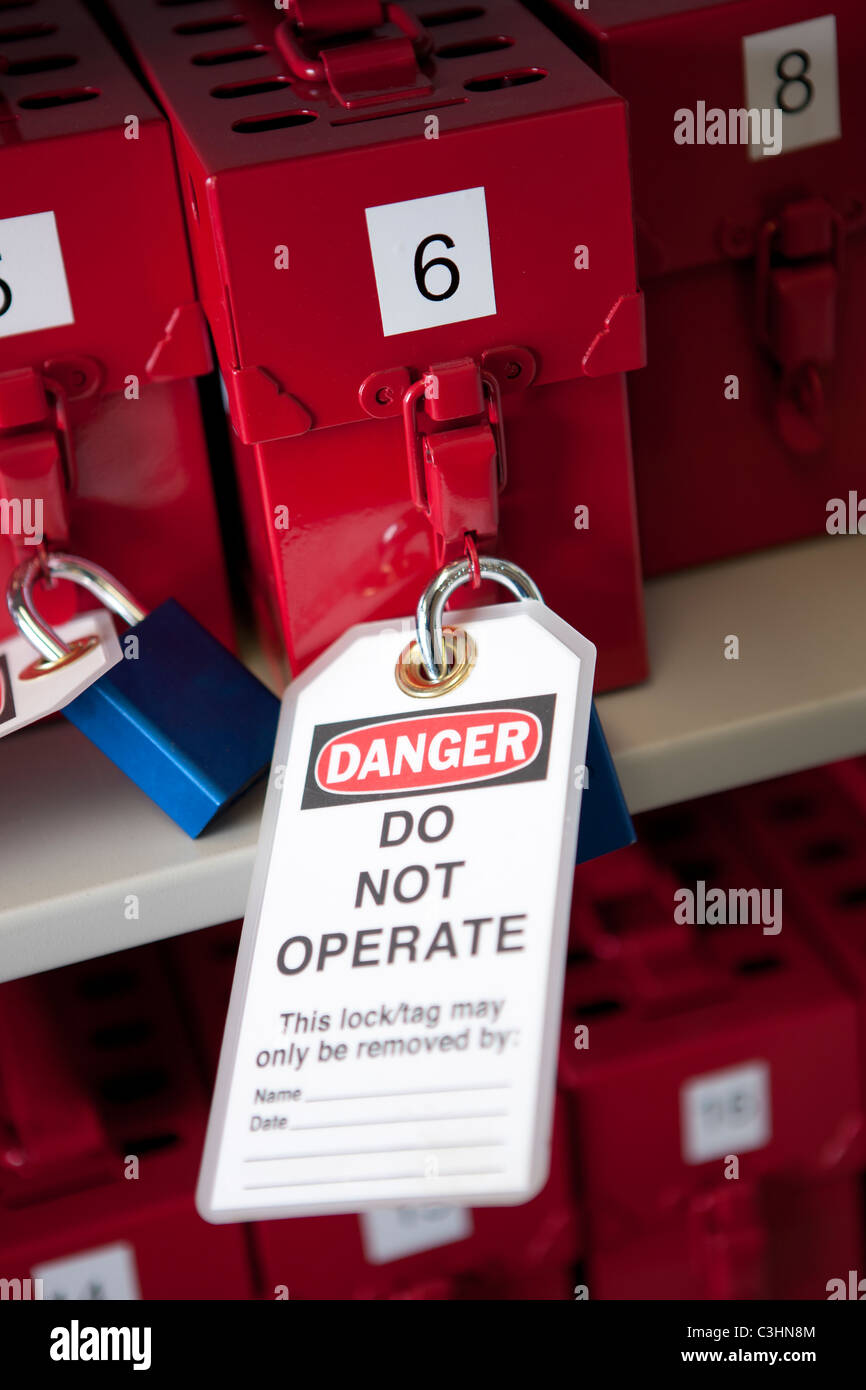 Danger tag on lock Stock Photo - Alamy