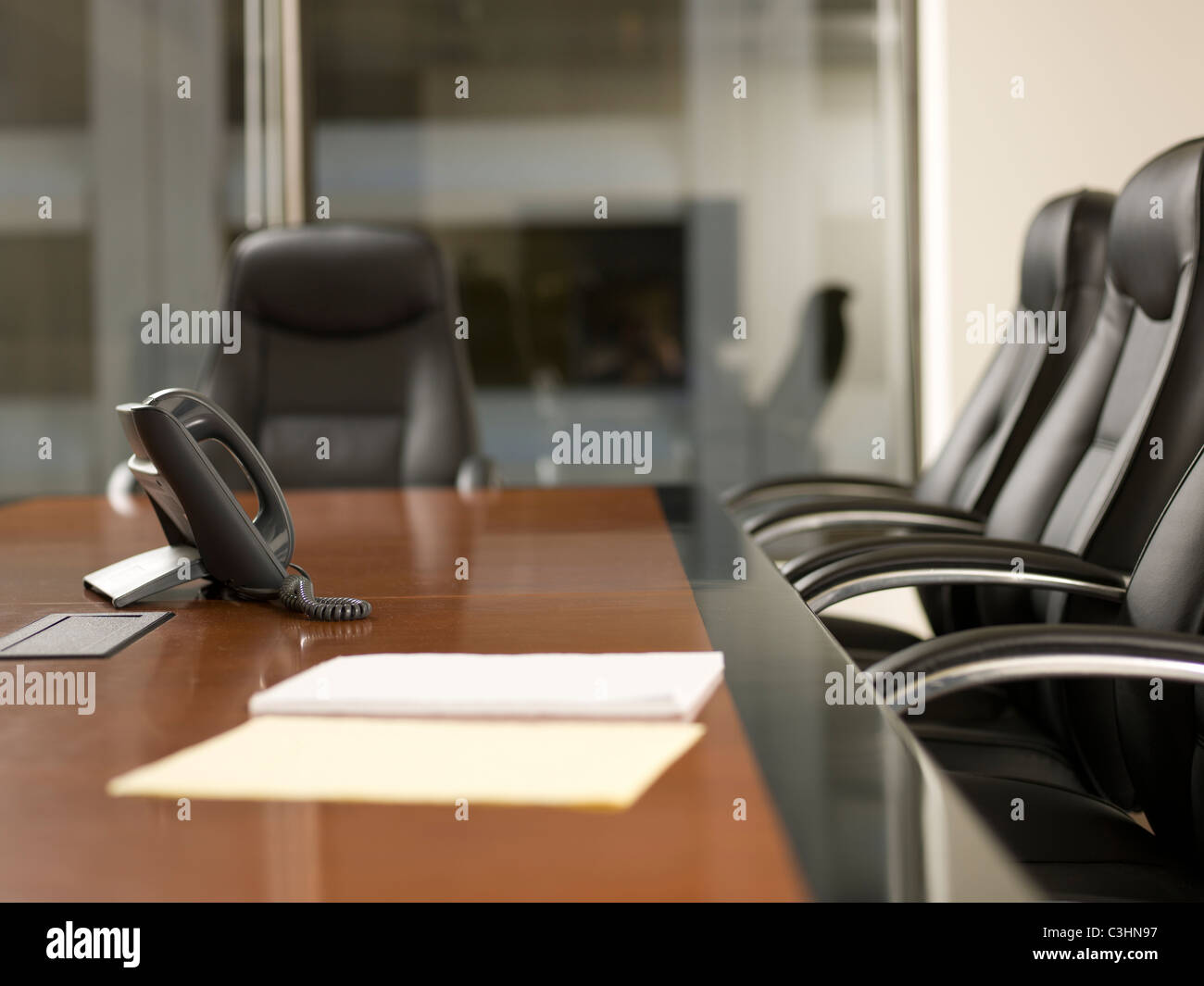 Paper and telephone in board room Stock Photo - Alamy