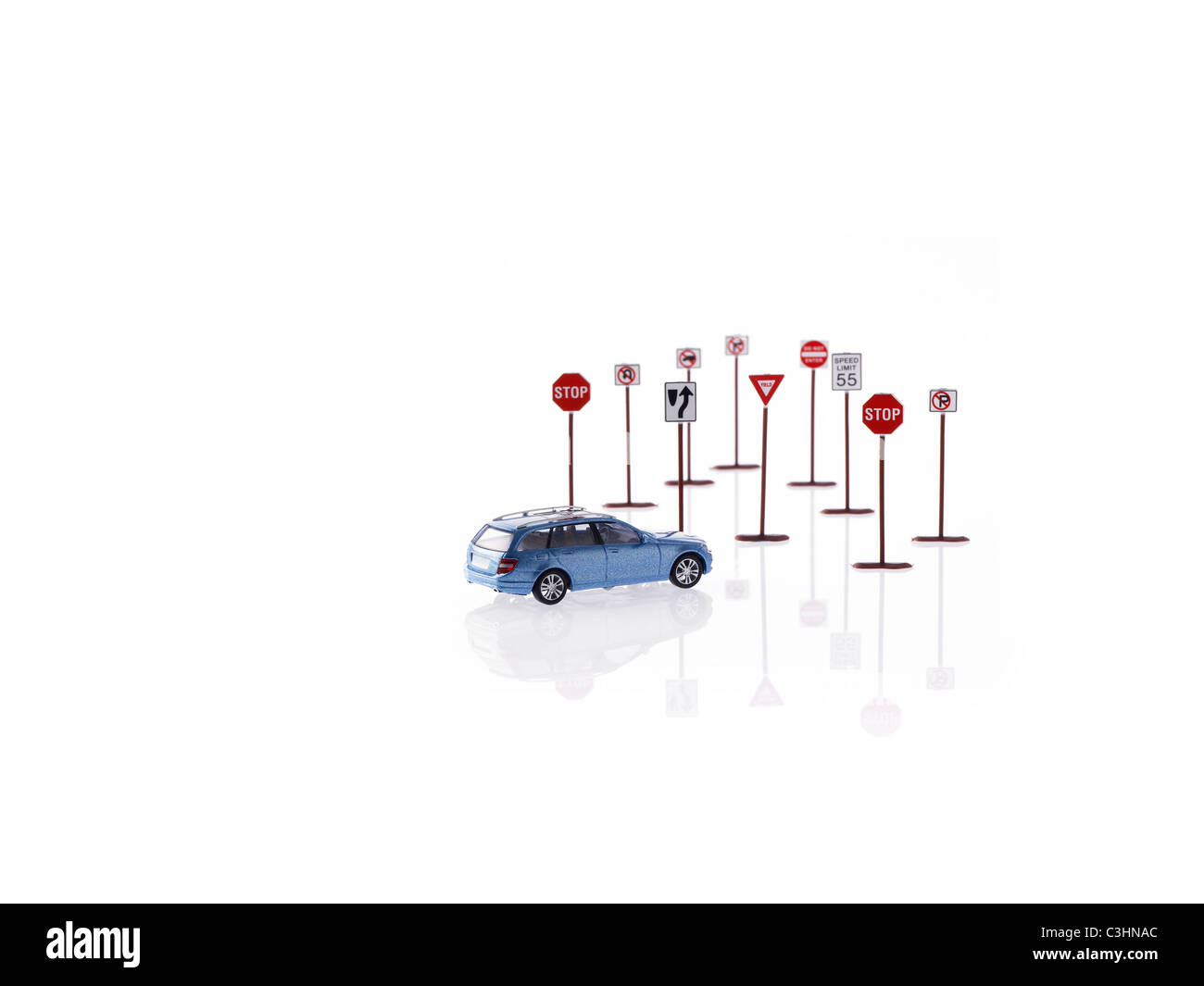 Studio shot of toy road signs and car Stock Photo - Alamy
