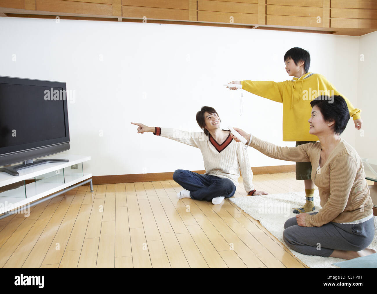 Three-generation family playing video games Stock Photo - Alamy