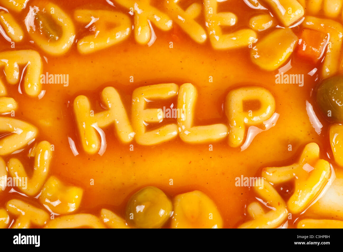 Alphabet shaped pasta forming the word HELP in tomato sauce Stock Photo ...