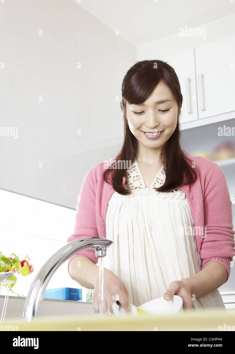 Woman washing dishes Stock Photo - Alamy