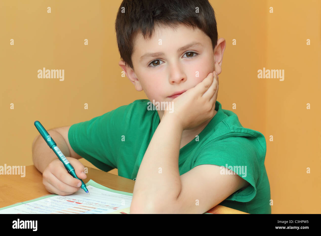 boy doing homework from school in workbook Stock Photo - Alamy