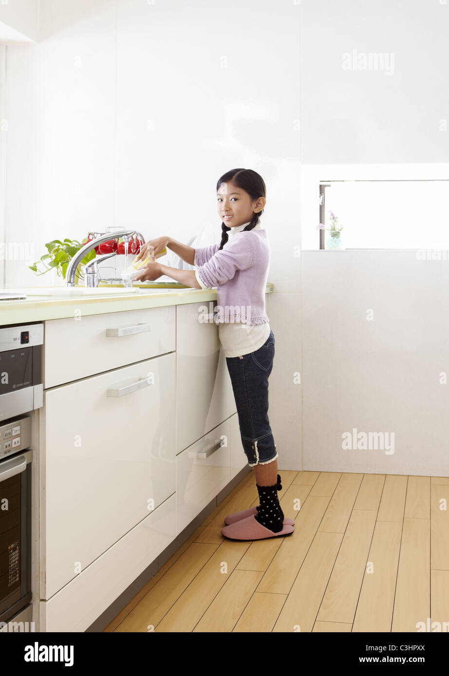 Girl washing dishes Stock Photo - Alamy
