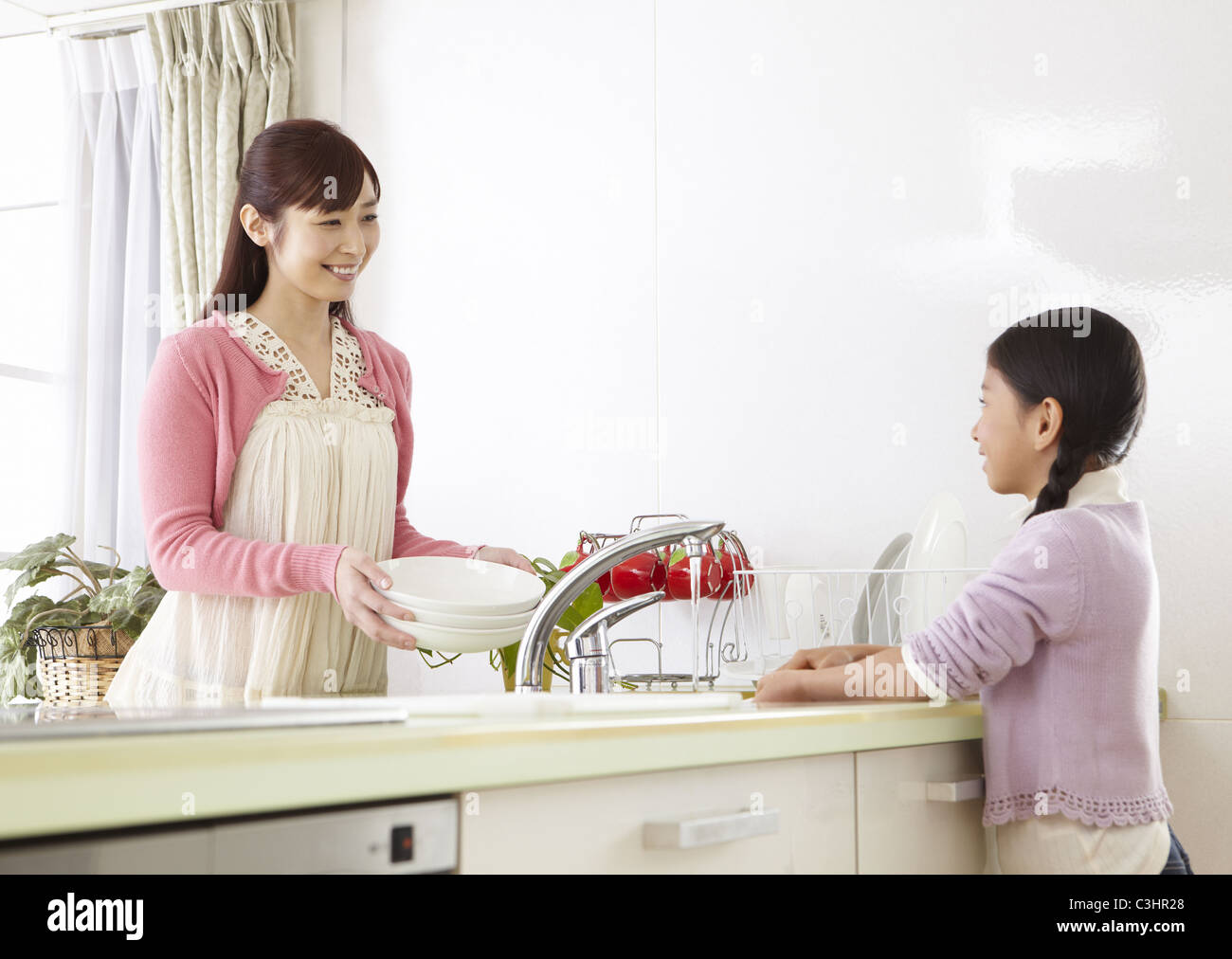 Mother and daughter washing dishes Stock Photo - Alamy