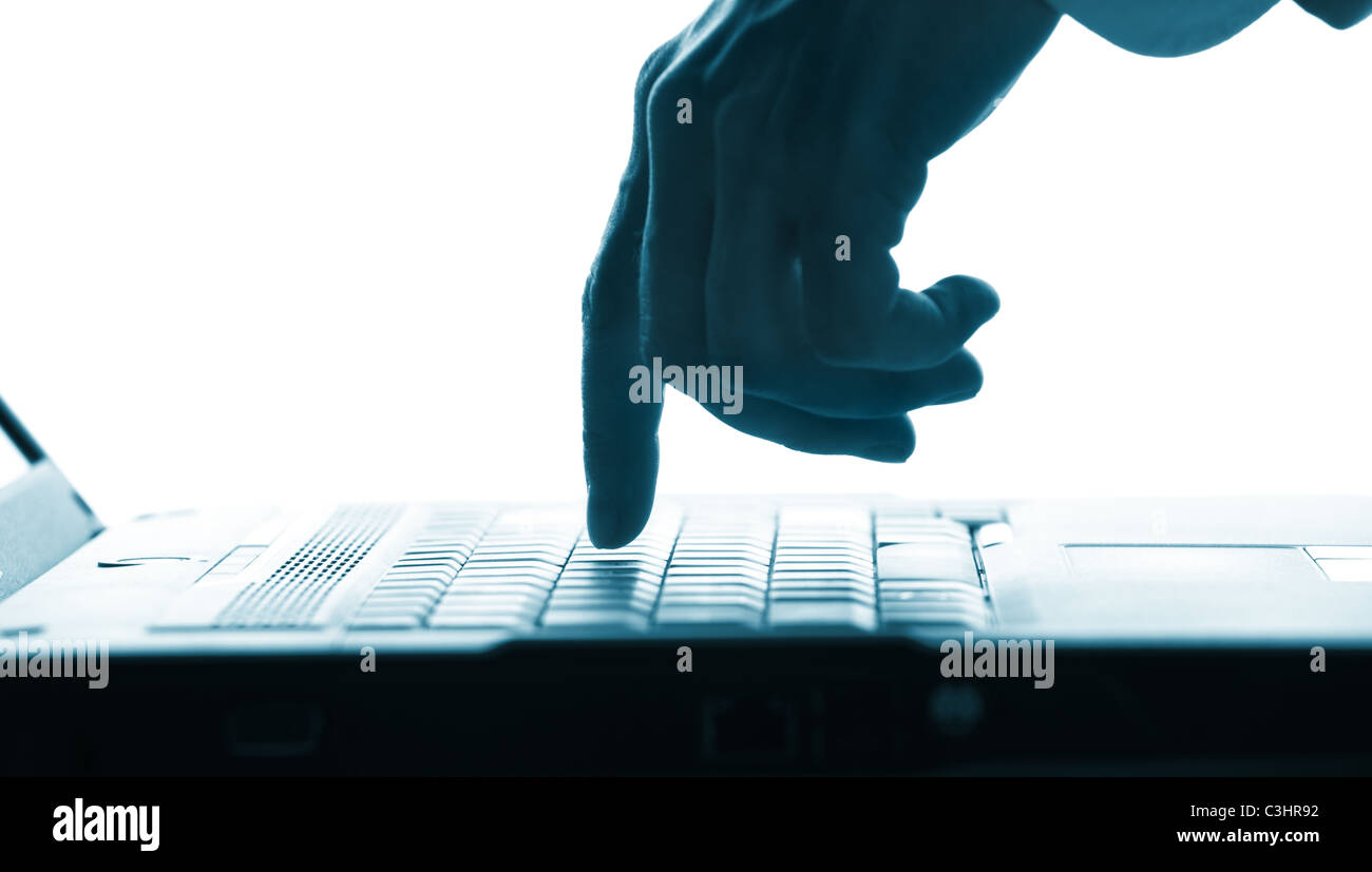 Close-up of hand touching computer keys during work Stock Photo - Alamy