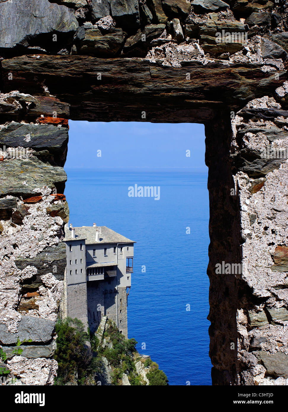 Monastery St. Dionisiou on Mount Athos through a stone window, Greece ...