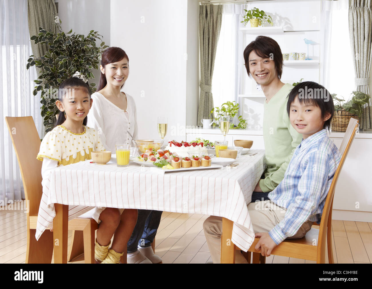 Parents and kids having a birthday party Stock Photo - Alamy
