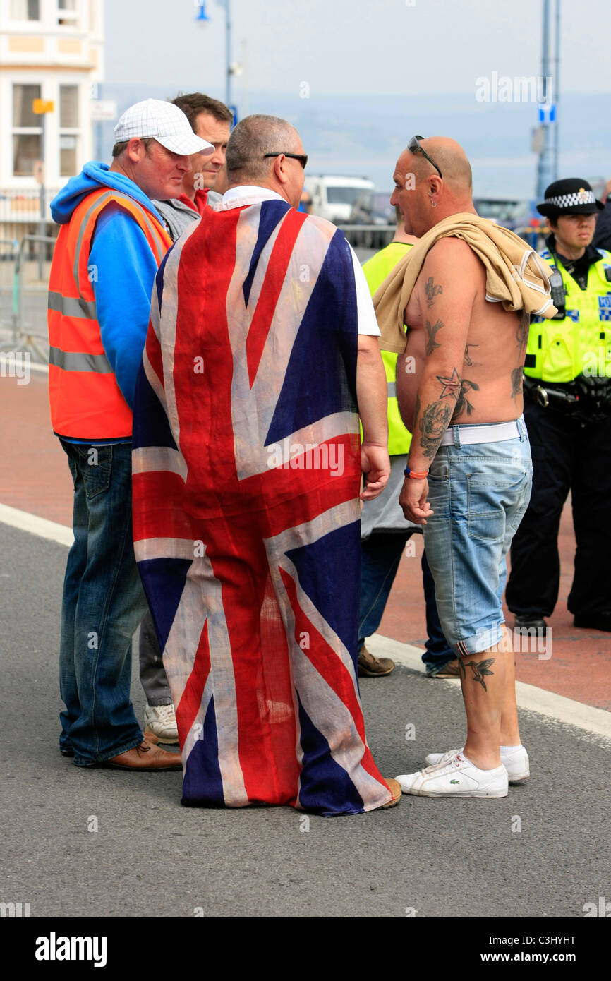 A member of the EDL using a Union Jack flag as a cape at a ...