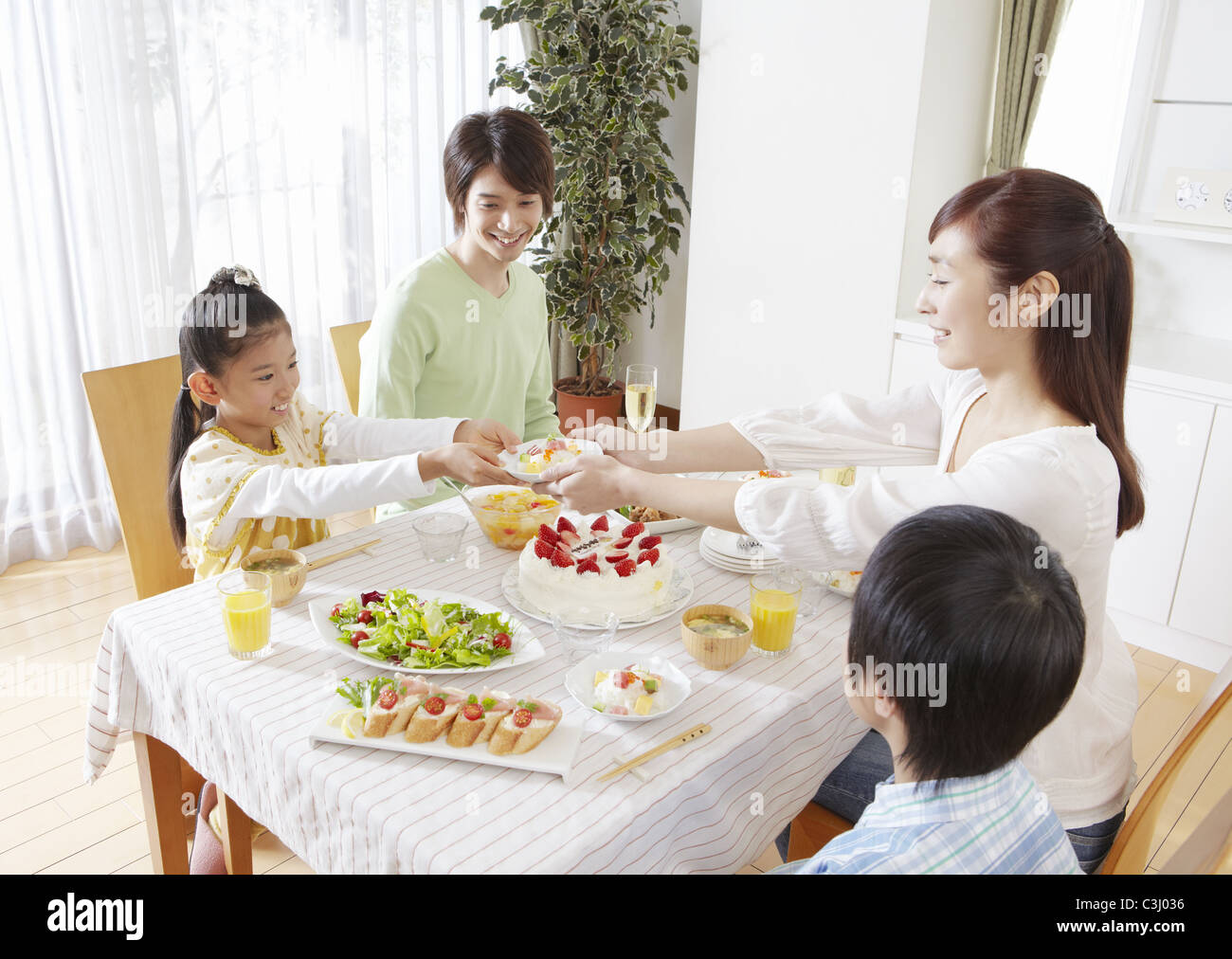 Parents and kids having a birthday party Stock Photo - Alamy