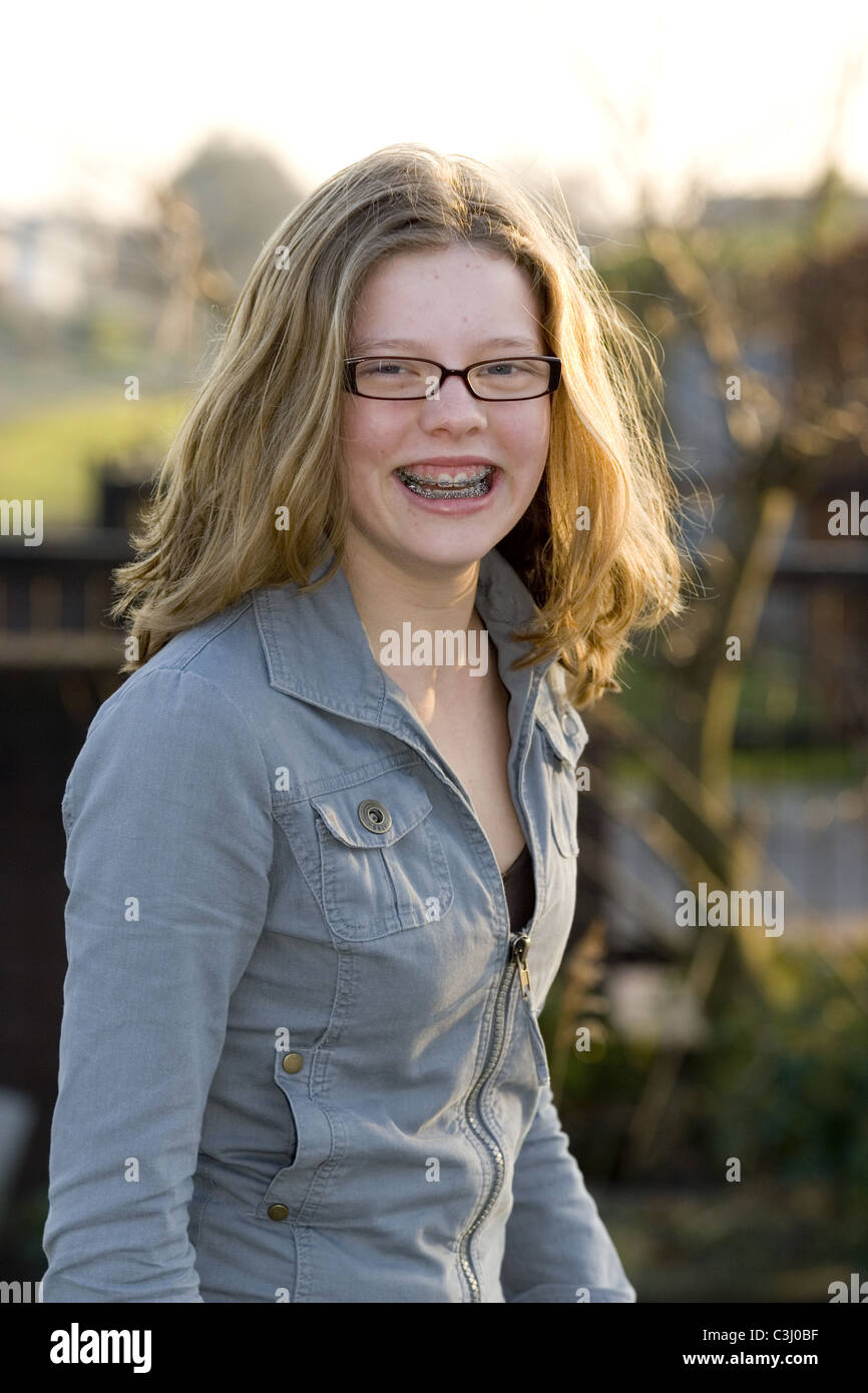 Happy portrait teenage girl age 12 with dental braces smiling and look ...