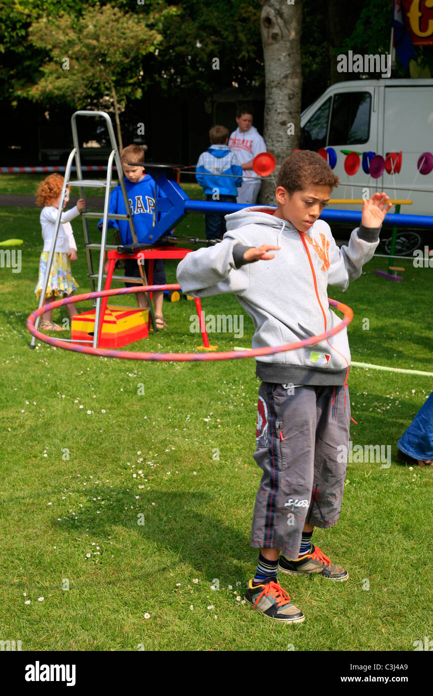 Young boy trying a hoola-hoop at a circus workshop day Stock Photo - Alamy