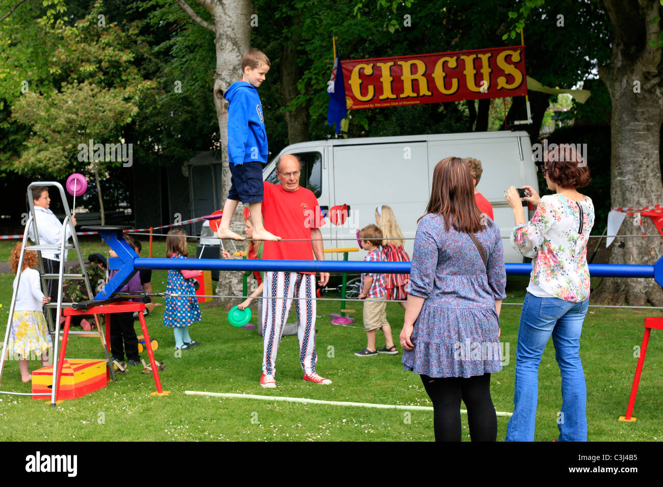 Young boy trying to walk on a tightrope at a circus workshop day Stock ...