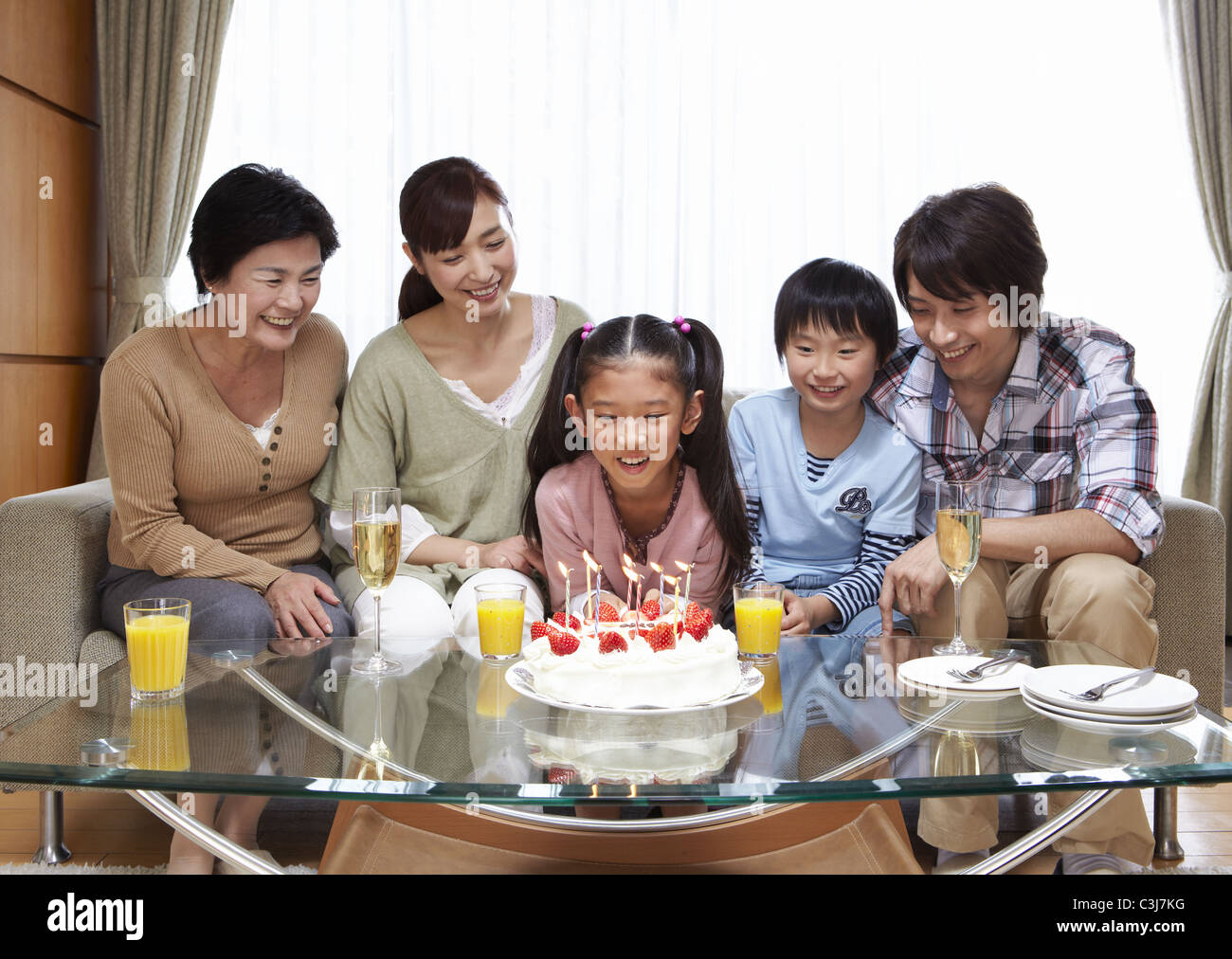 Three-generation family having a birthday party Stock Photo - Alamy
