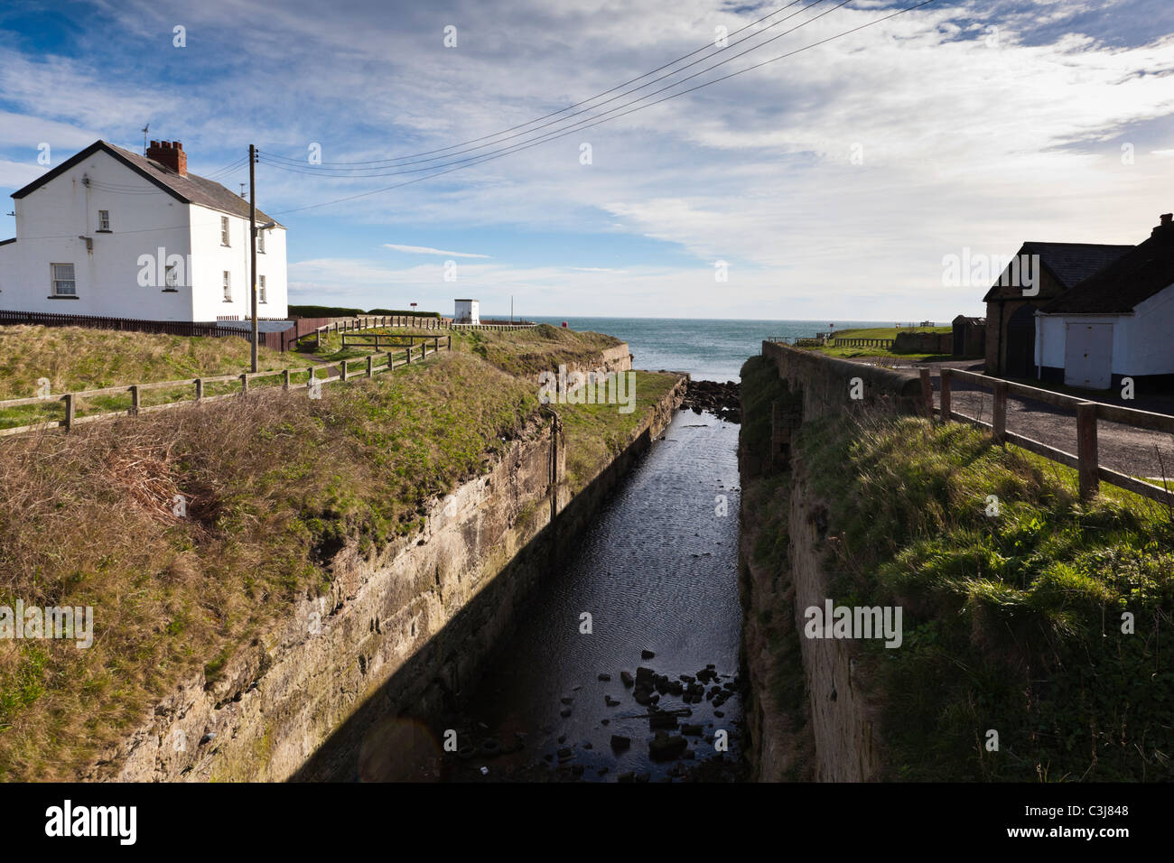 The Sluice Channel and house at Seaton Sluice, Northumbria, UK Stock ...