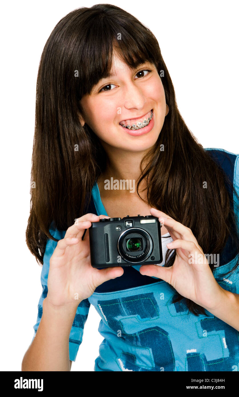 Portrait of a teenager photographing with a camera and smiling isolated ...