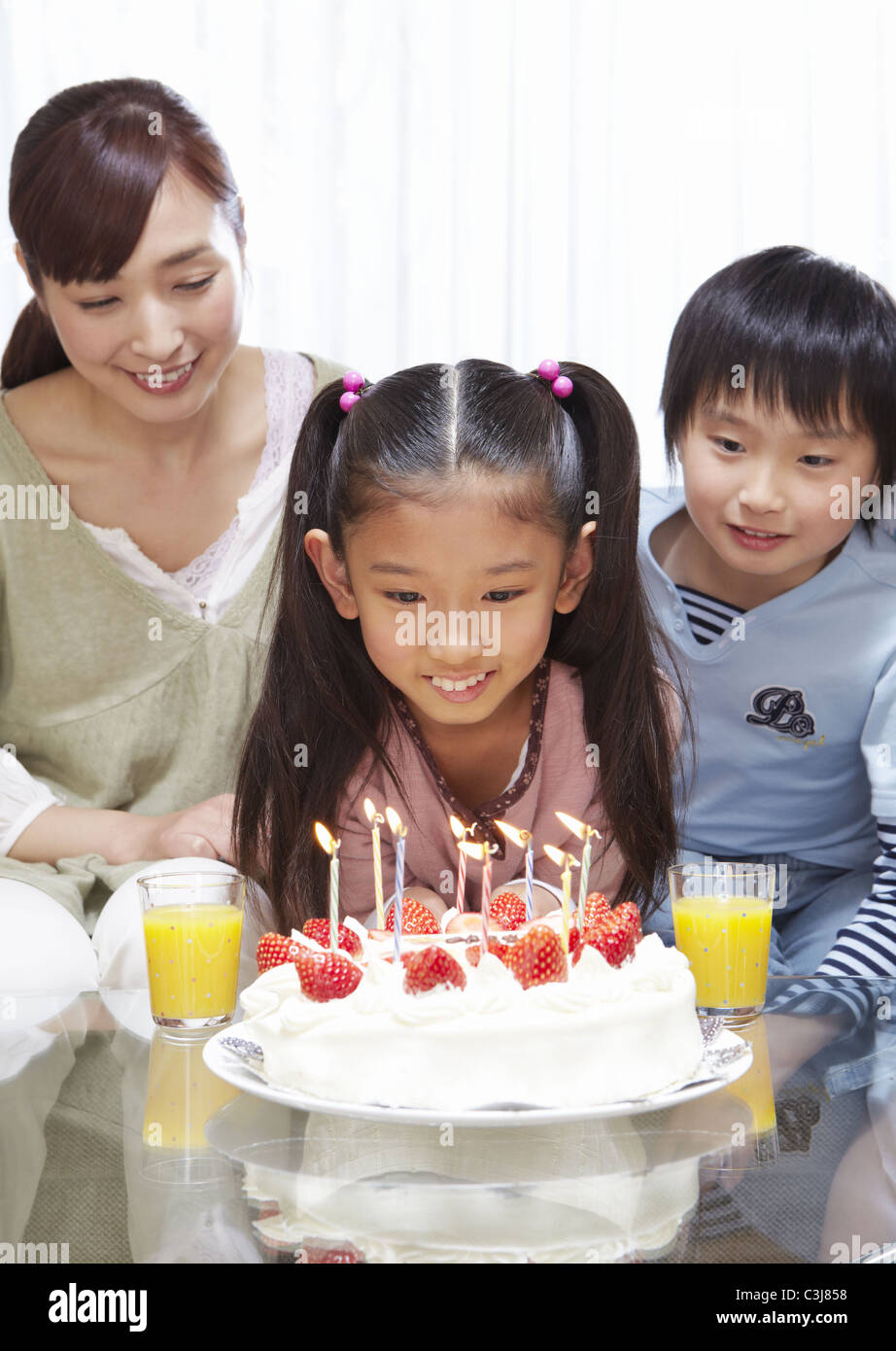 Parents and kids having a birthday party Stock Photo - Alamy