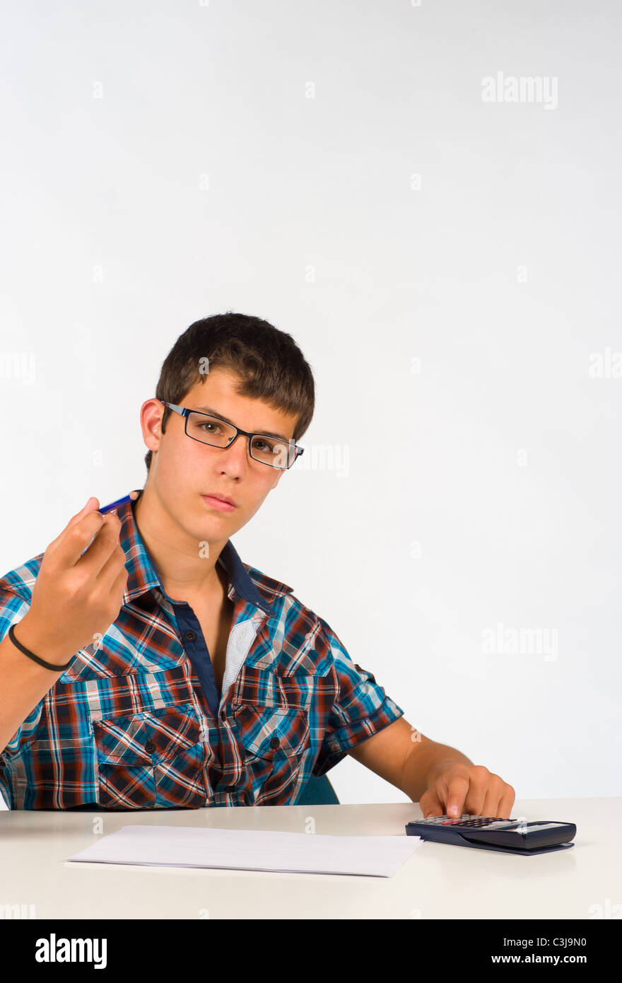 Teenager working for his maths subject with a calculator Stock Photo ...