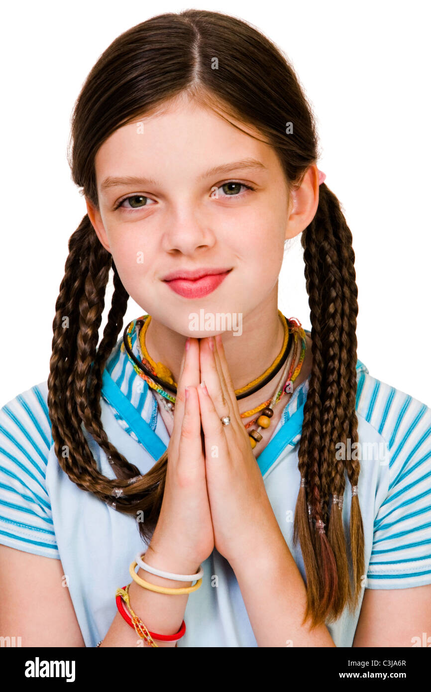 Confident girl praying and smiling isolated over white Stock Photo - Alamy