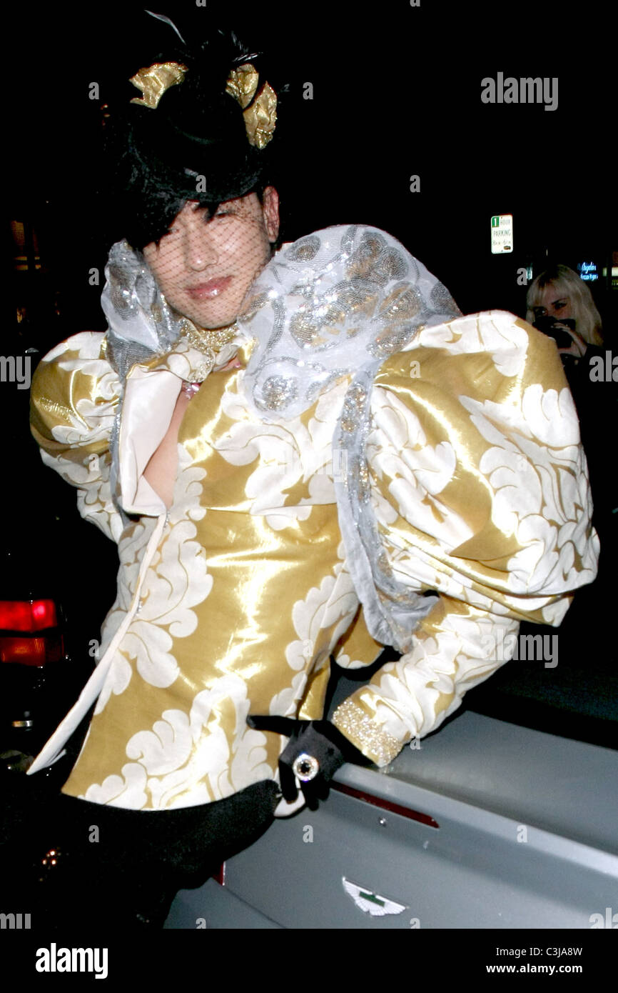 Bobby Trendy poses for photographers in an ornate gold jacket while on ...