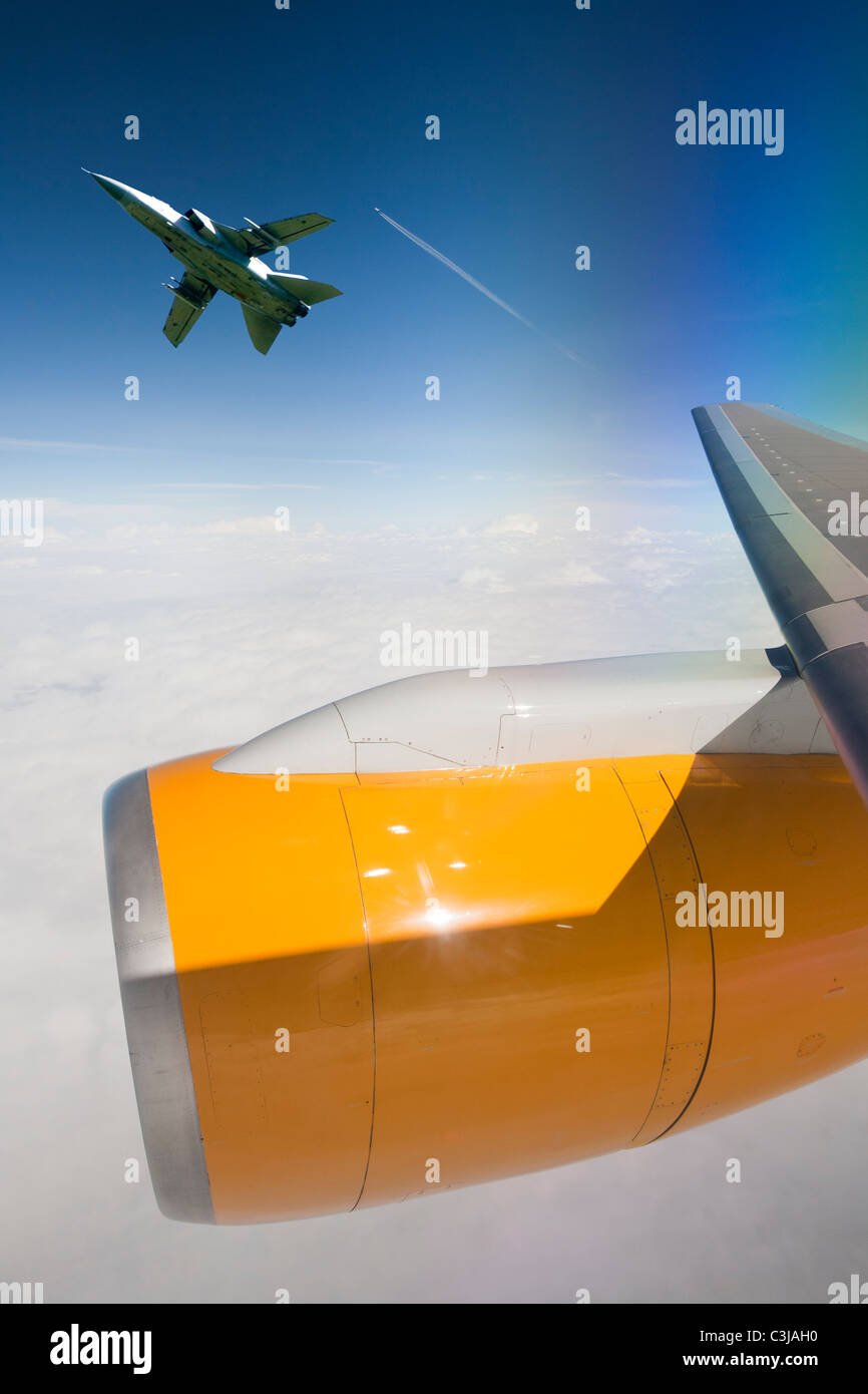 A jet engine on a plane with a contrail from another jet in the back ...