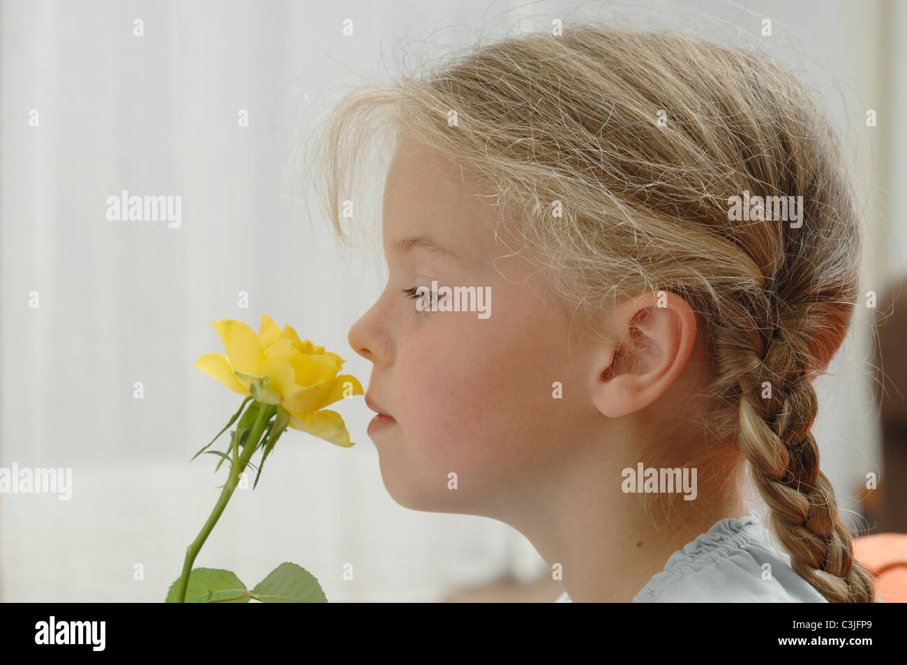 Child smelling rose hi-res stock photography and images - Alamy