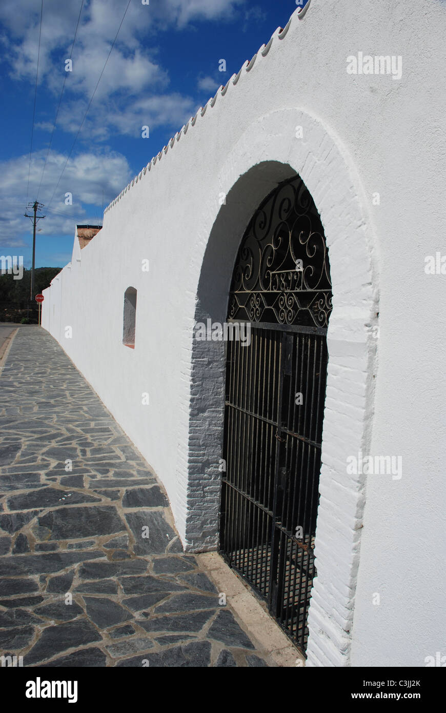 Spanish white wall with traditional gate Stock Photo - Alamy
