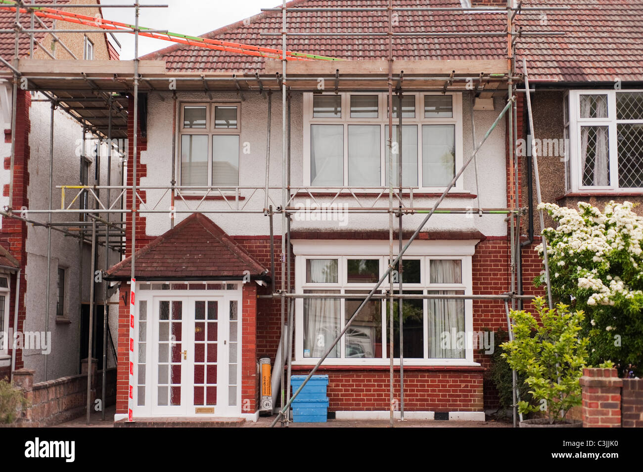 Semi detached suburban house in London with scaffolding erected in ...