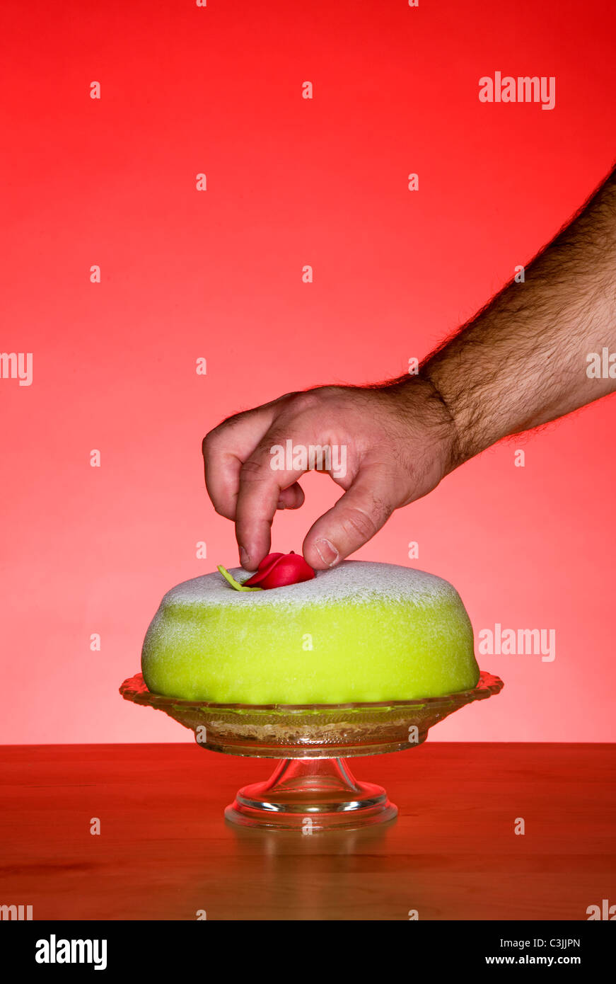 Human hand taking marzipan from dessert hi-res stock photography and ...