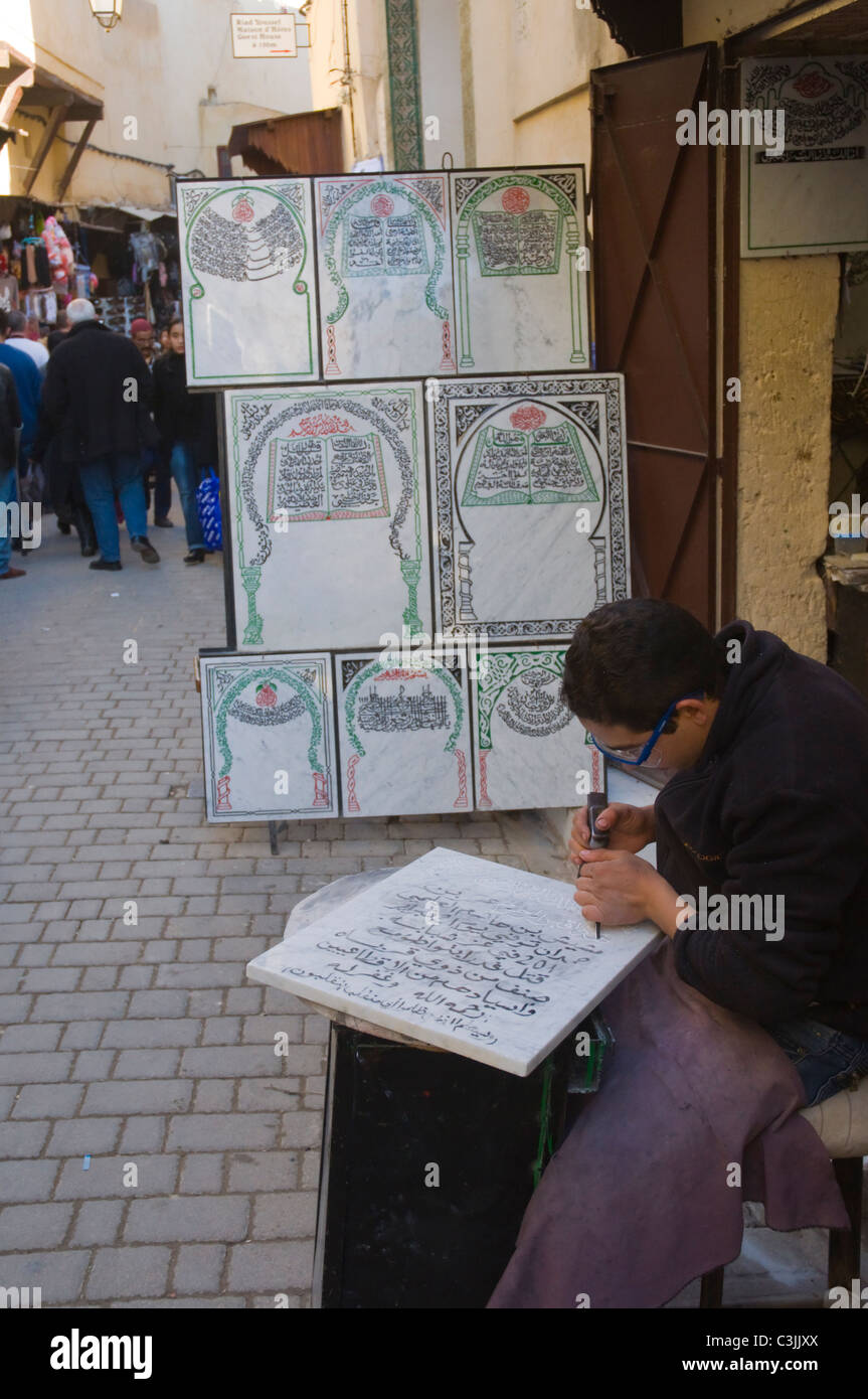 Artisan carving Arabian letters Medina (Fes el-Bali) old town Fez ...