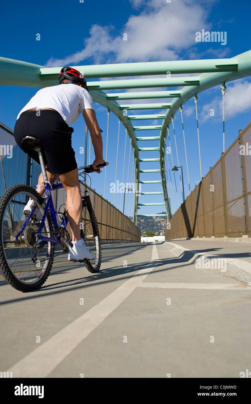 Cyclist on bridge Stock Photo - Alamy
