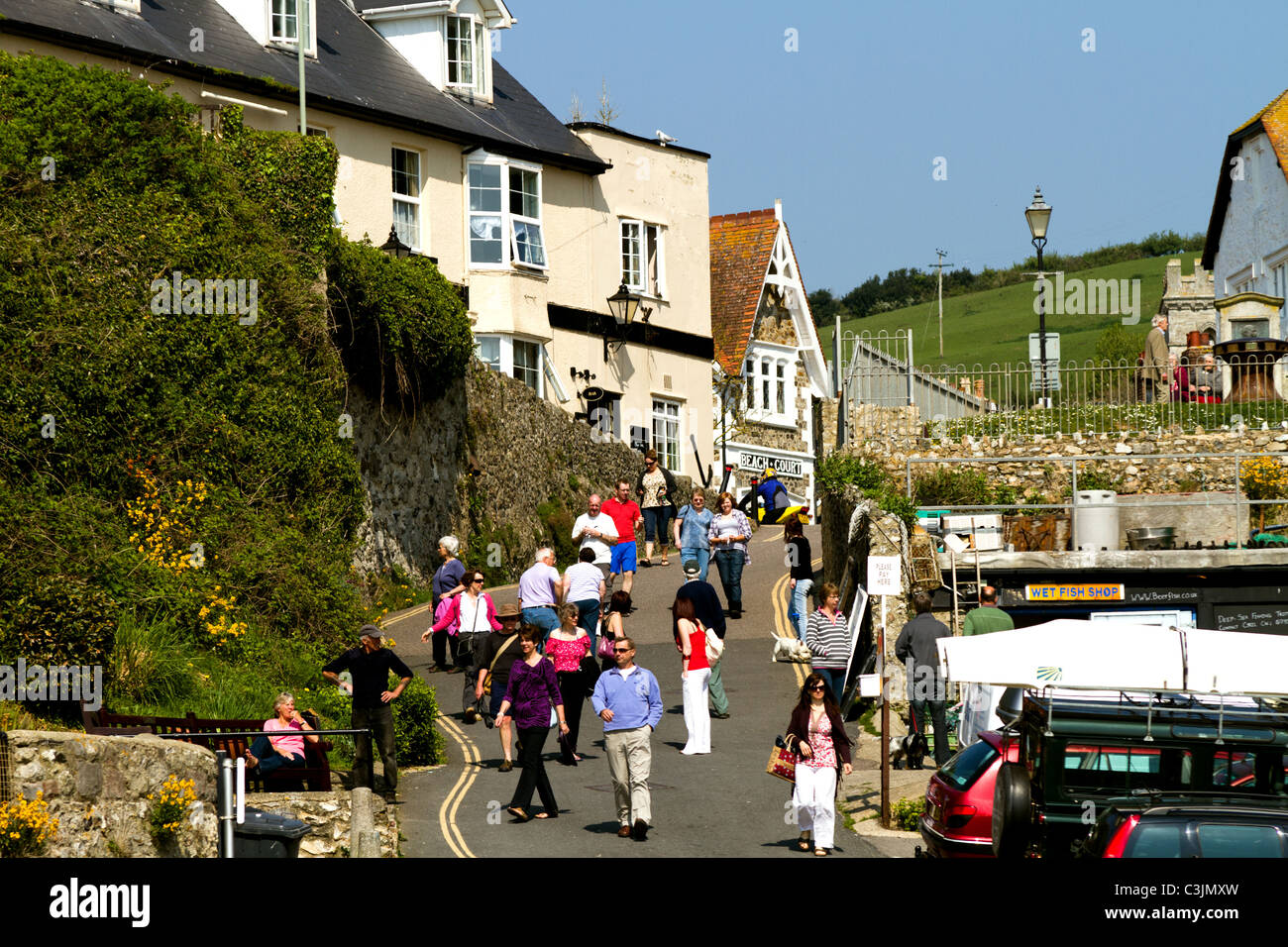 Tourists walking down to the beach at the foot of the hill in Beer ...