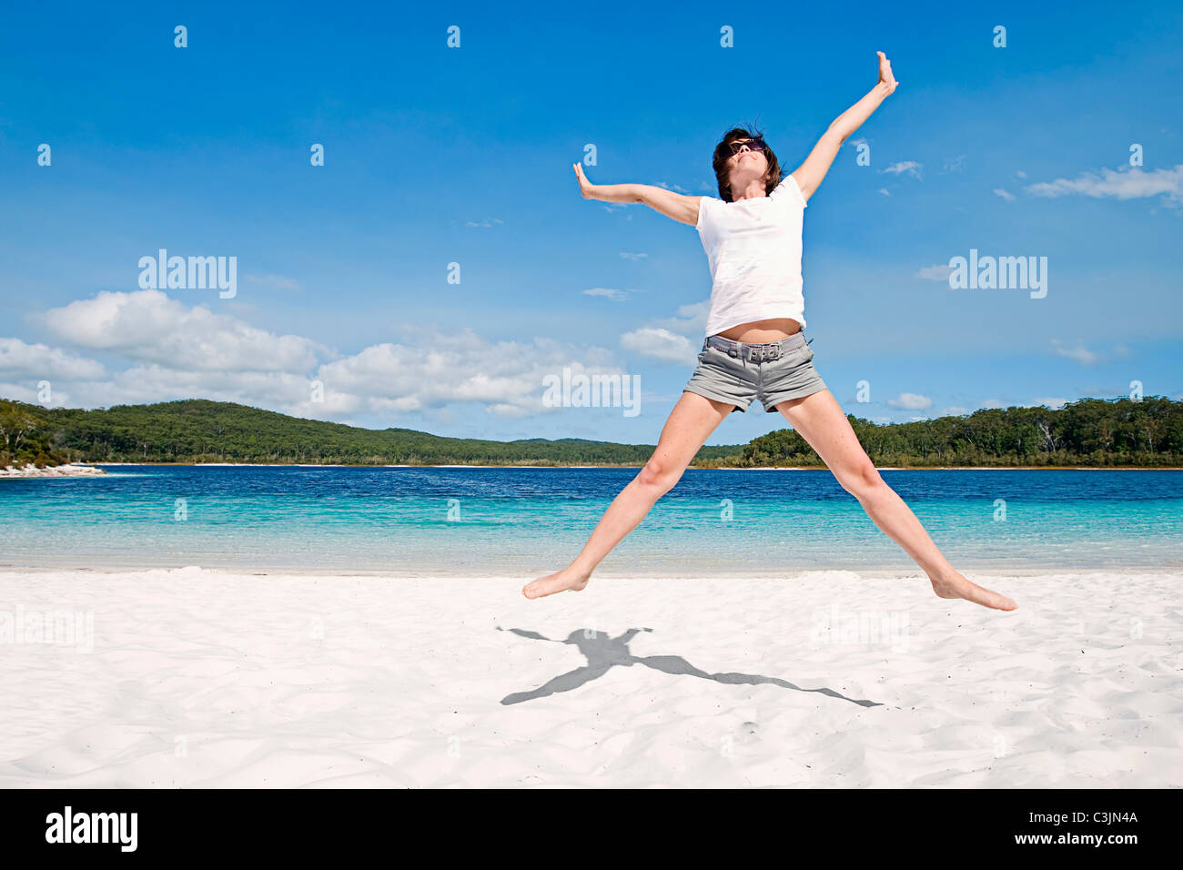 Woman cheering on beach Stock Photo - Alamy