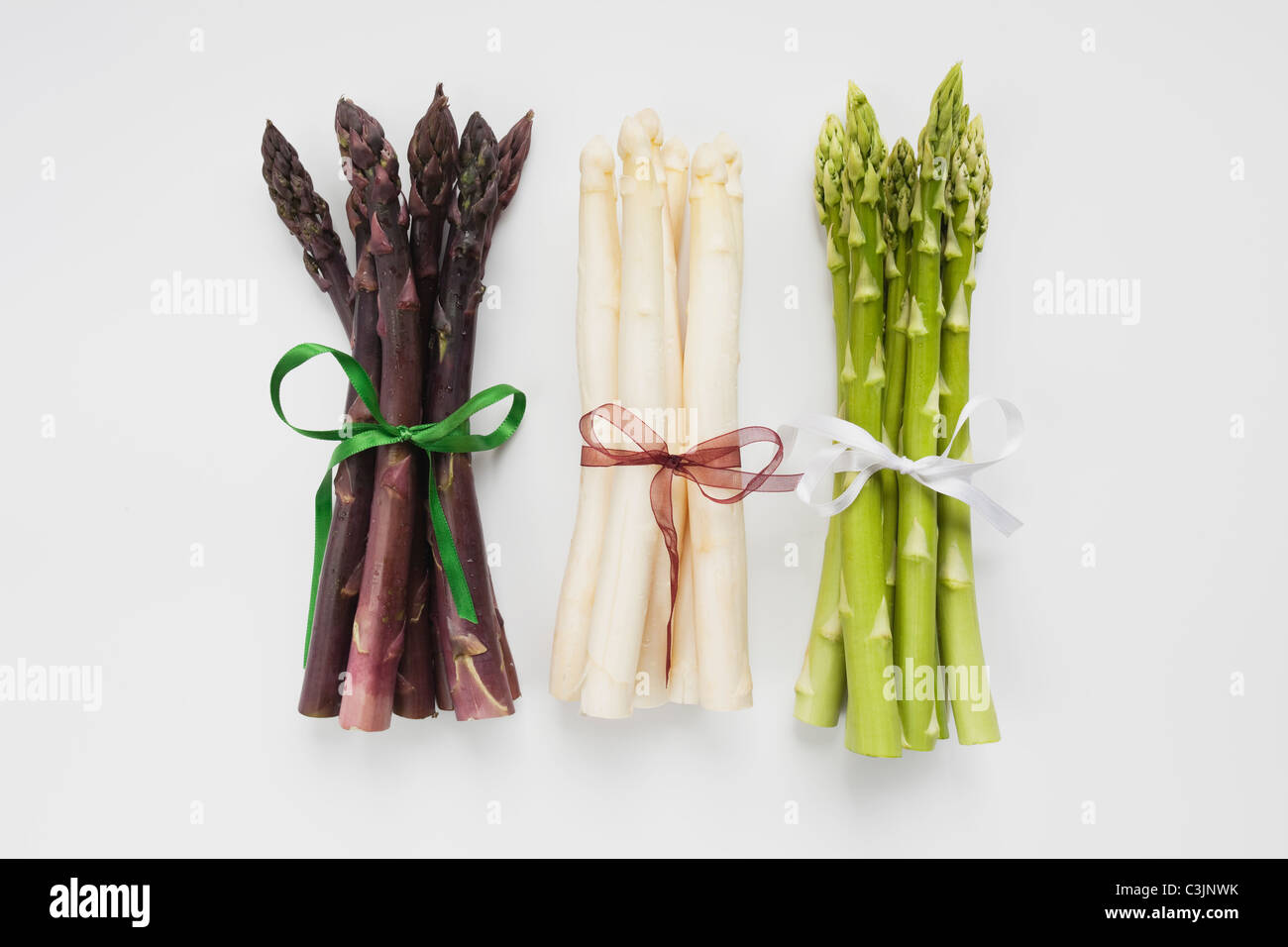 Bundle of various asparagus on white background Stock Photo - Alamy