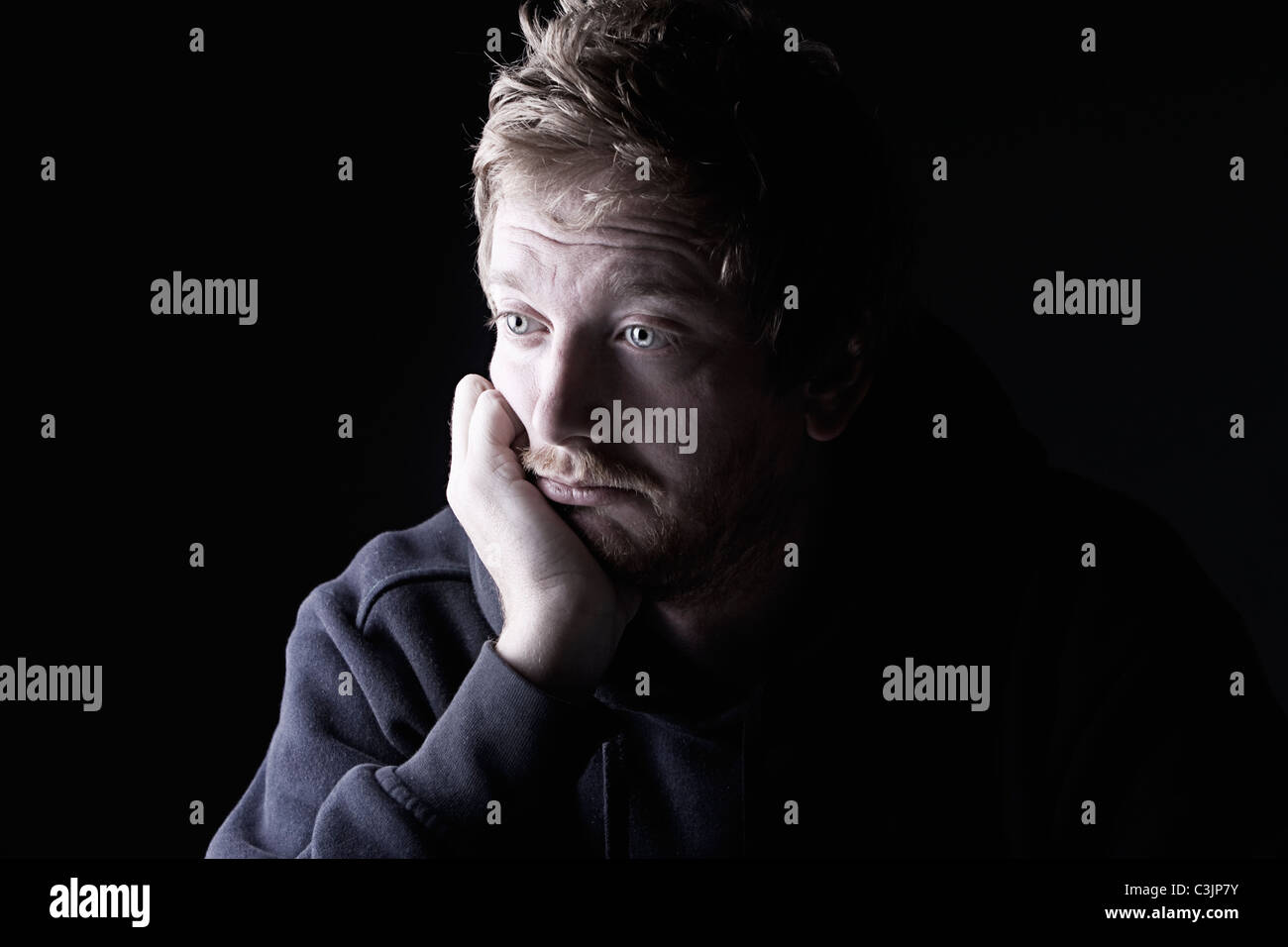 Studio portrait of sad man Stock Photo - Alamy