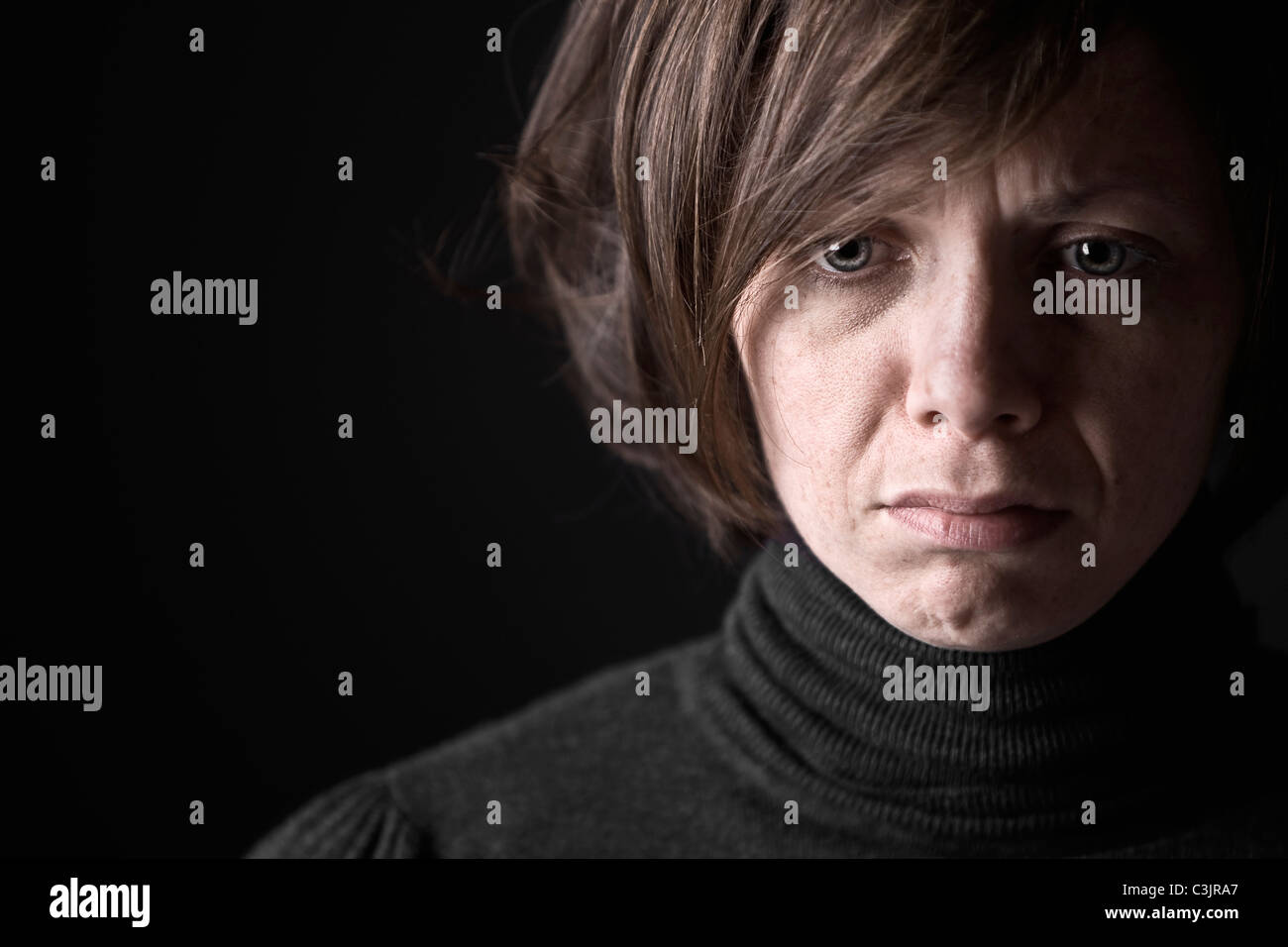 Studio portrait of sad woman Stock Photo - Alamy