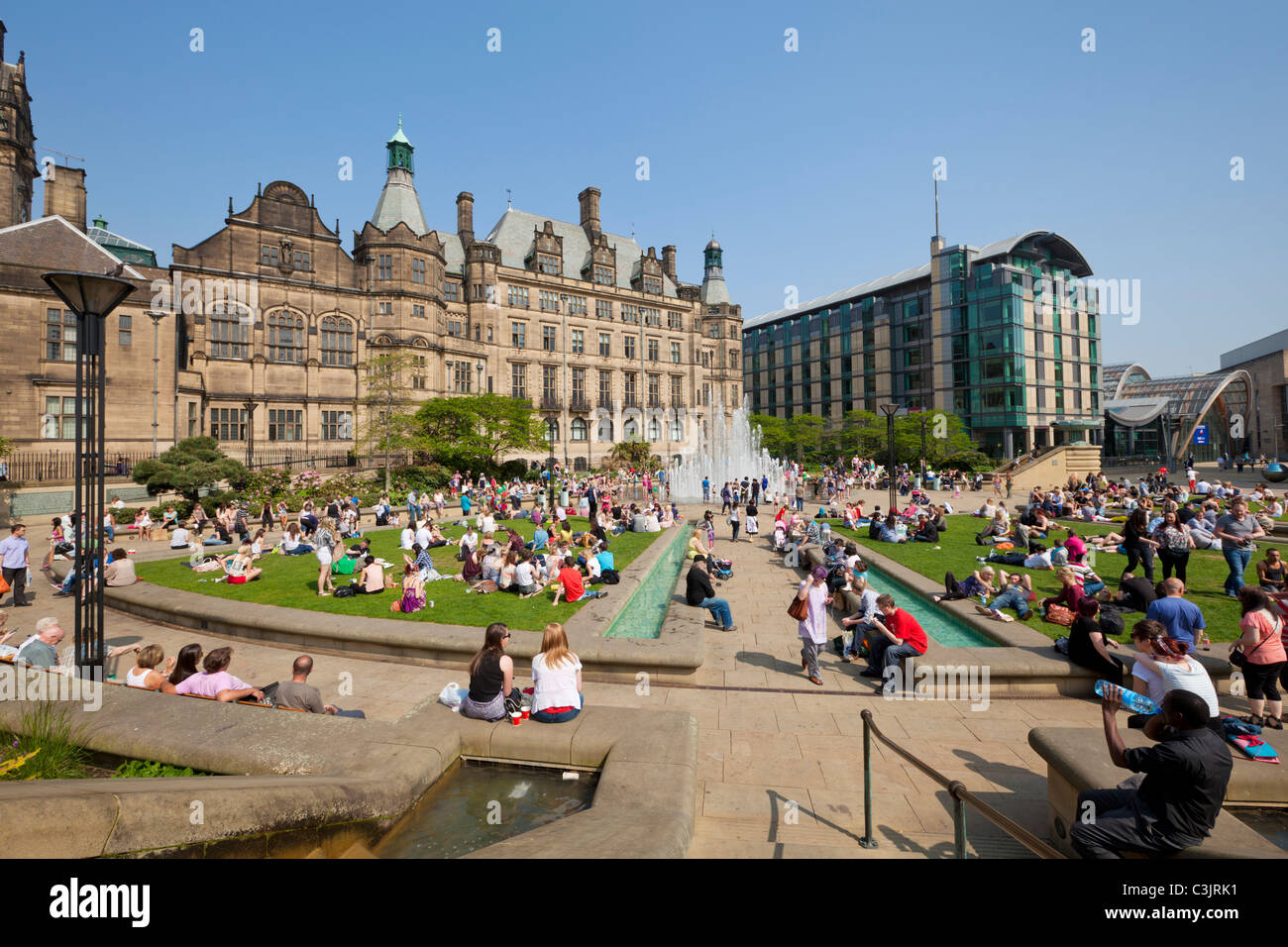 Gothic town hall and crowds of people in the Peace gardens with Goodwin ...