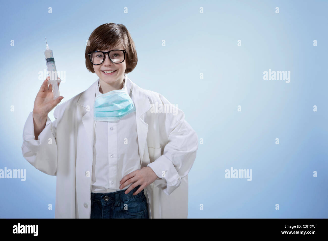 Boy dressed as doctor and holding a medical injection, portrait Stock ...