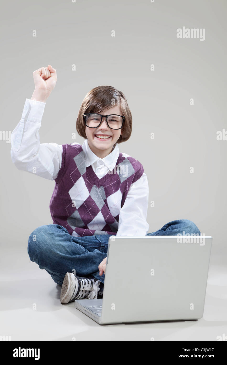Boy using laptop, smiling, portrait Stock Photo - Alamy