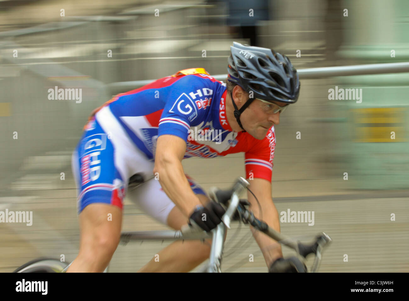 Man cycling in city centre road race Stock Photo - Alamy